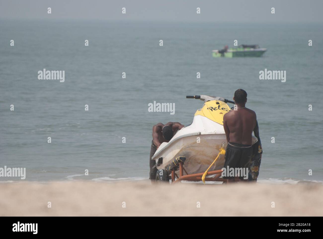 Man pulling Jet Ski from Sea onto Southern Goan beach in India Stock ...