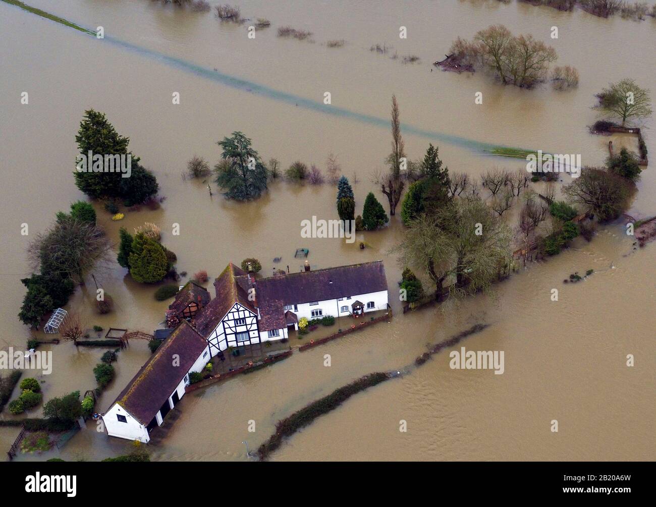 A house in Pixham, Worcestershire is surrounded in flood water after ...