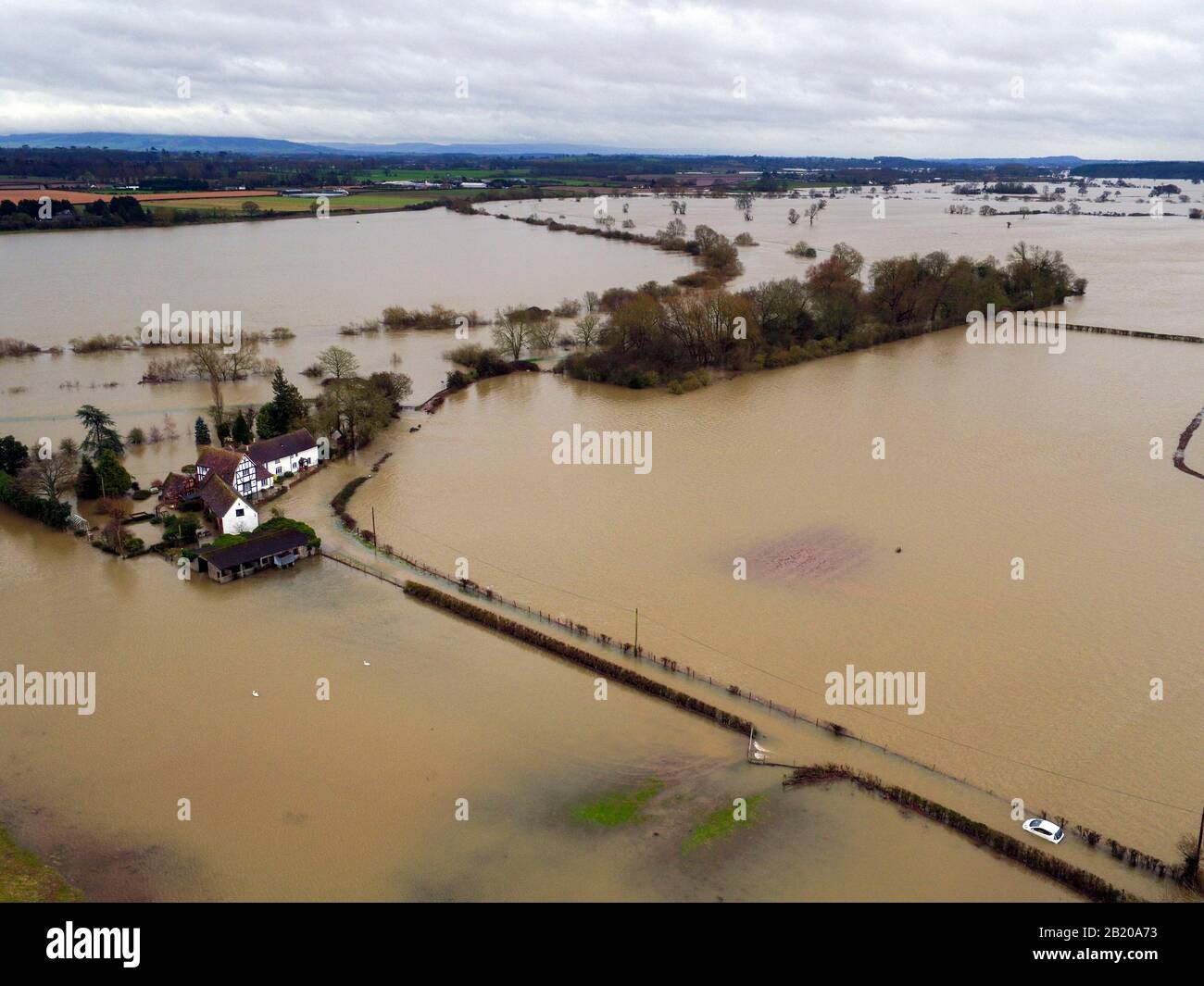 A house in Pixham, Worcestershire is surrounded in flood water after ...