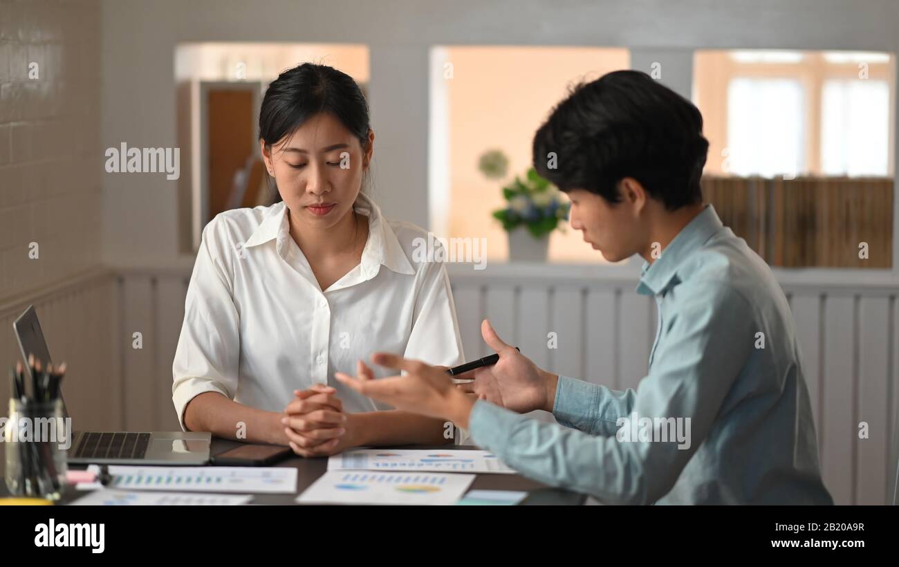 Business development team discussing/talking/meeting about their new ...