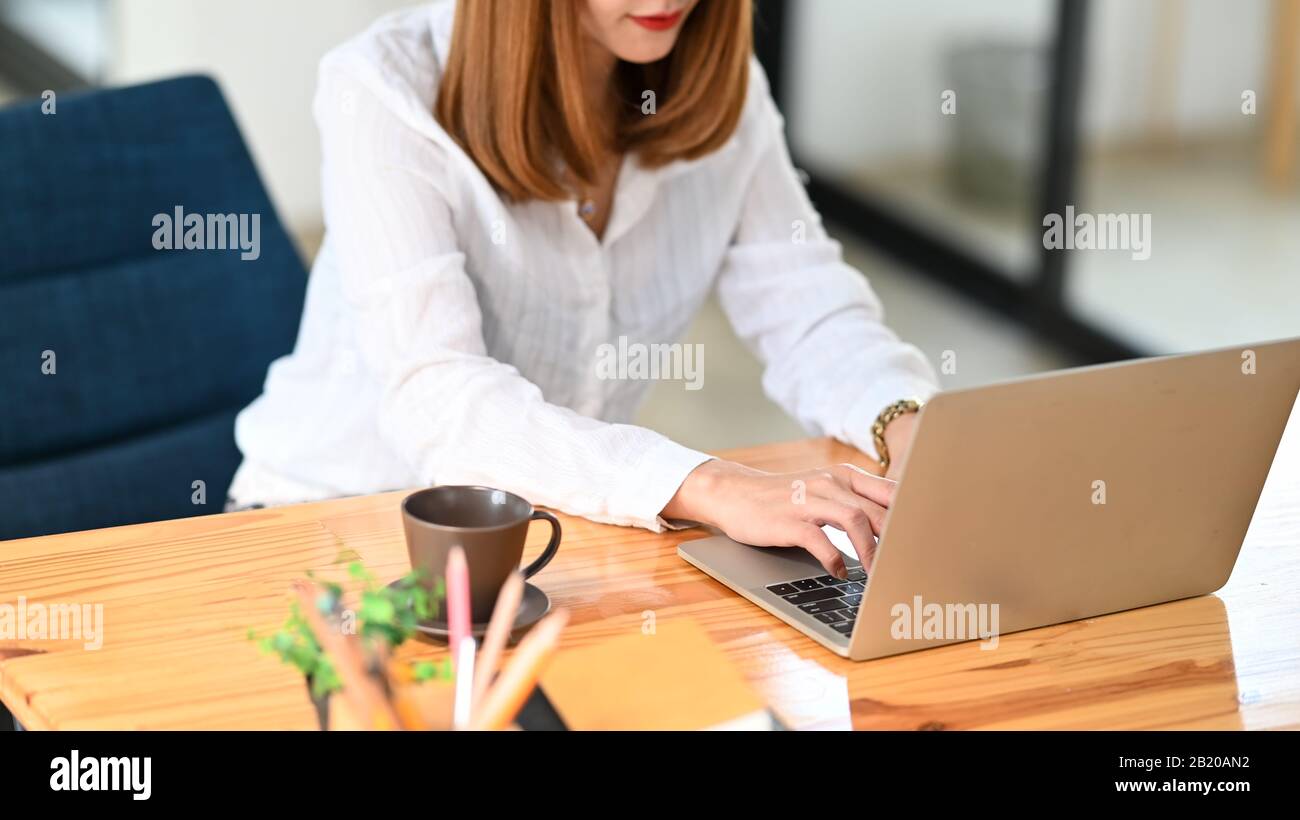 Photo of young creative woman working as secretary typing on computer ...