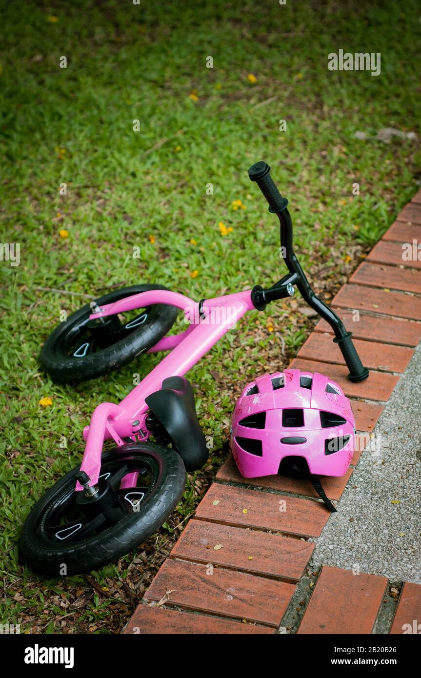 Pink bike for little girl. A pink bike parking in the park near the ...