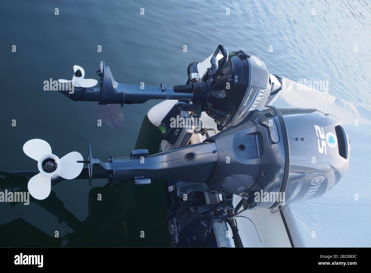 A close up view of a pair of Yamaha 25 outboard motors on the back of a ...