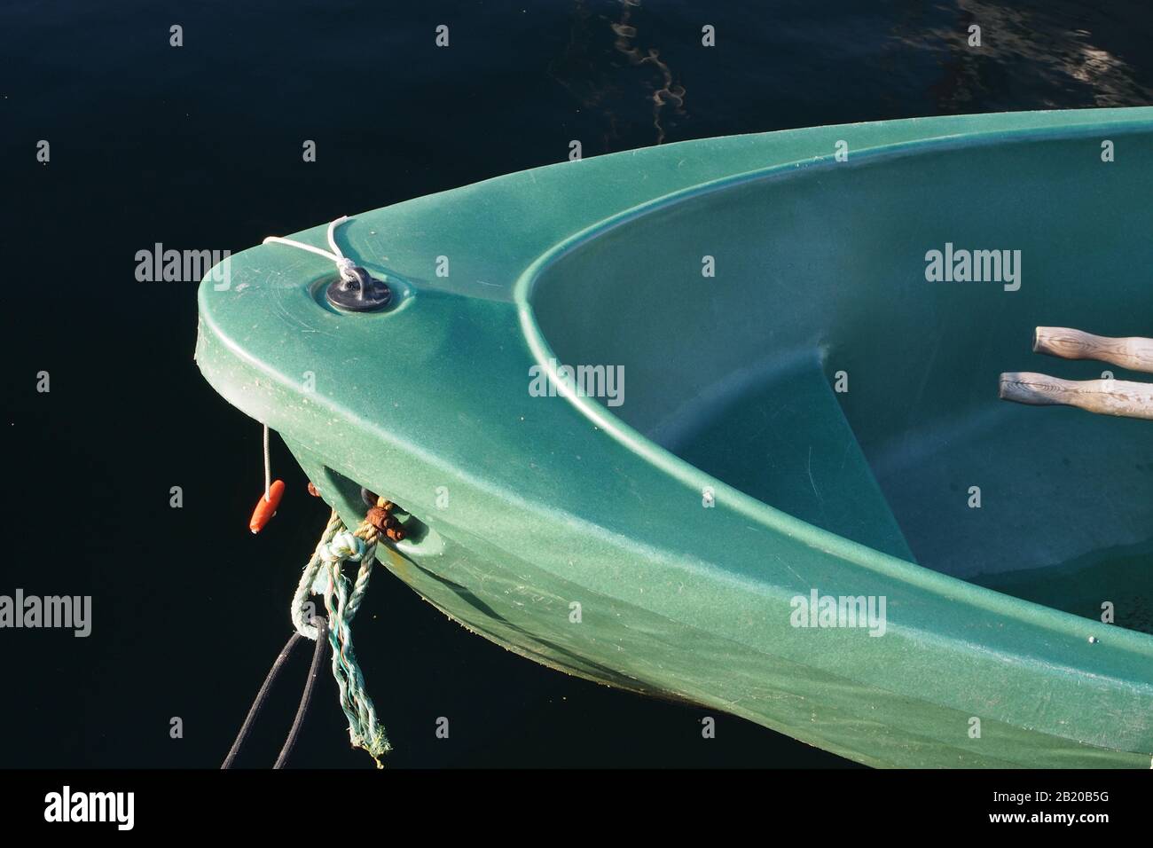 A close up view of the bow of green rowing boat just showing the handle ...