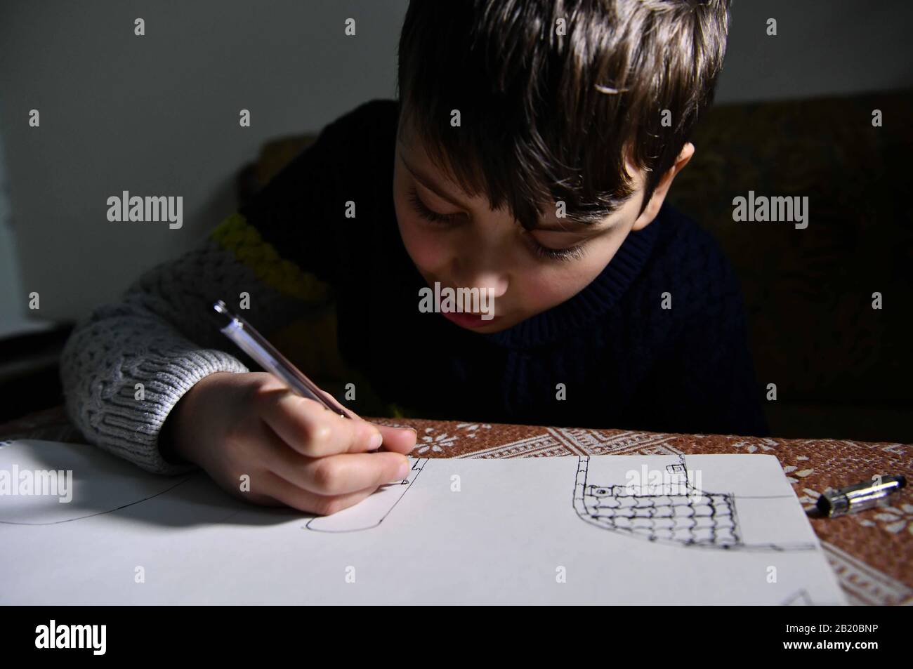 Homs, Syria. 17th Feb, 2020. Abdul-Rahman al-Asaad draws at his home in ...