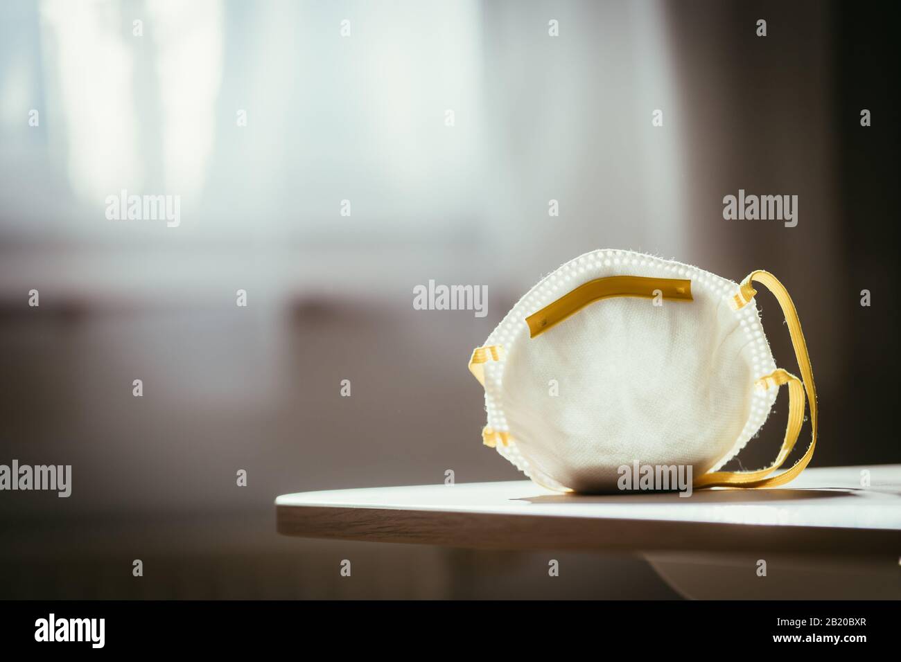 Breathing mask lying on a table. Flue and corona season Stock Photo - Alamy