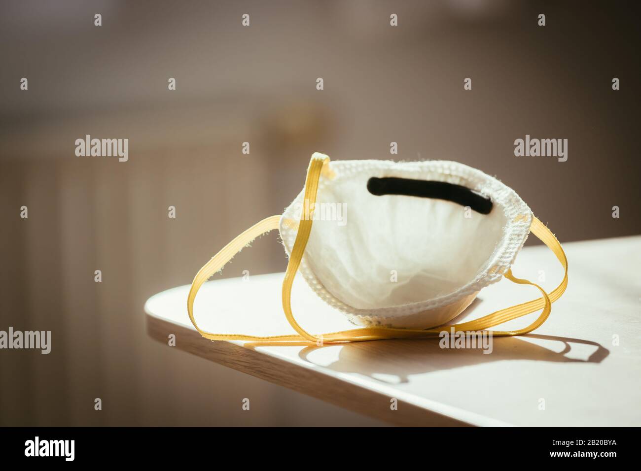 Breathing mask lying on a table. Flue and corona season Stock Photo - Alamy