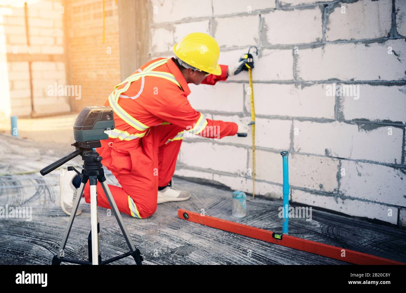 Technician with Laser measurement level during work Stock Photo - Alamy