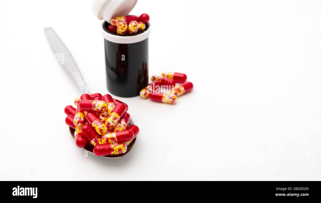Medical drug capsule on spoon on white background Stock Photo - Alamy