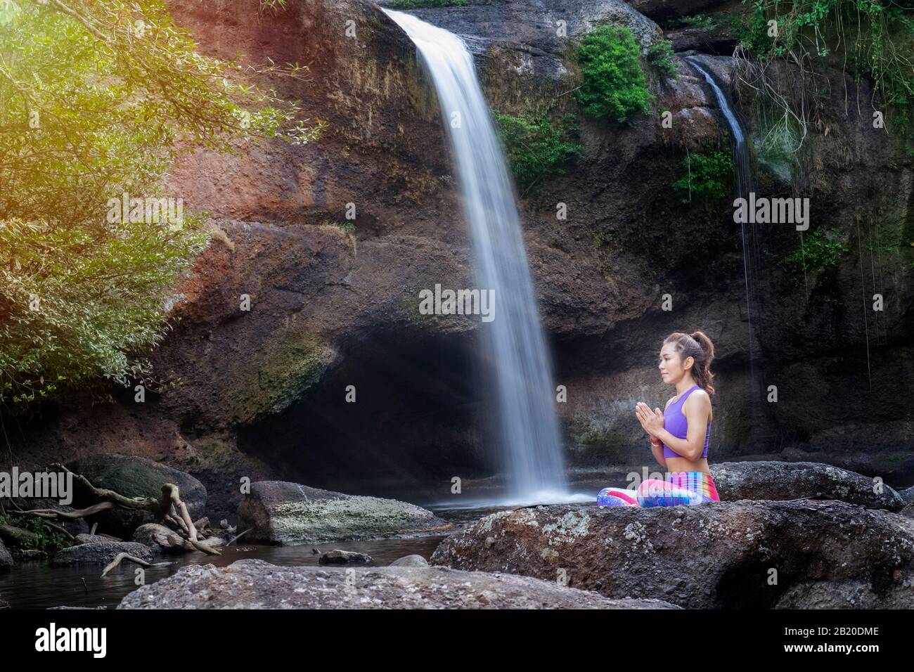 Woman yoga in front waterfall hi-res stock photography and images - Alamy