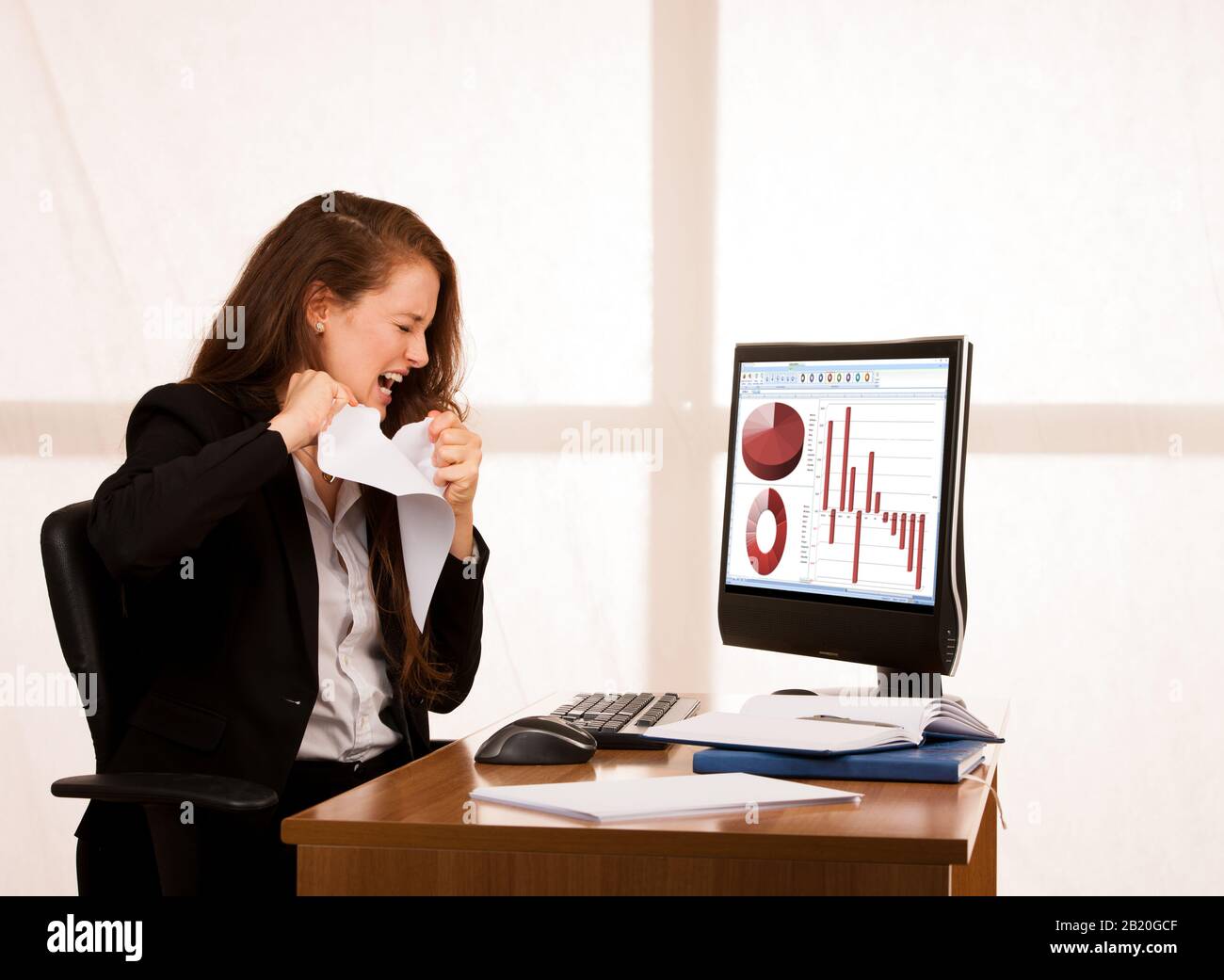 Angry business woman expressing rage at her desk in the office Stock ...
