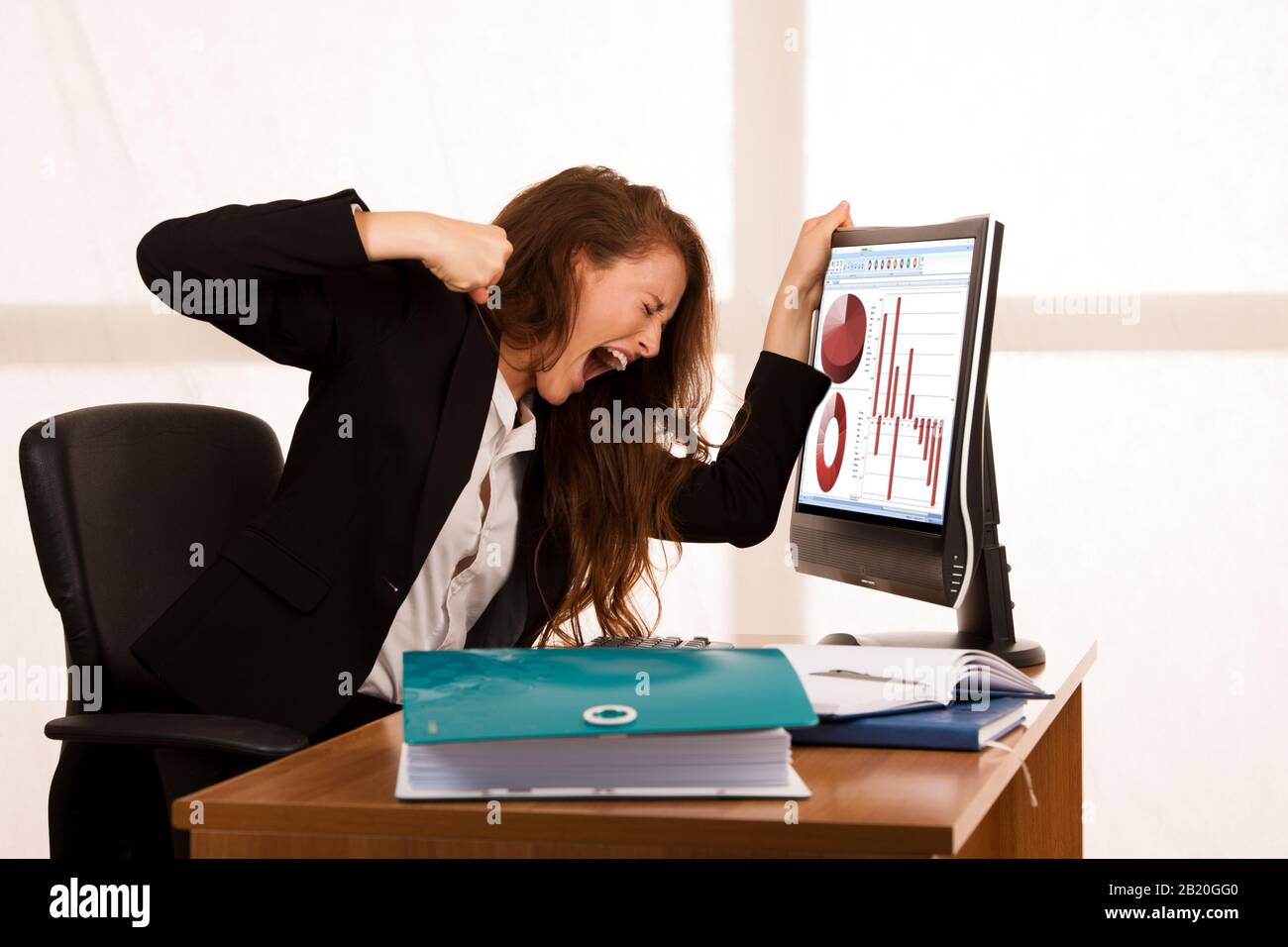 Angry business woman expressing rage at her desk in the office Stock ...