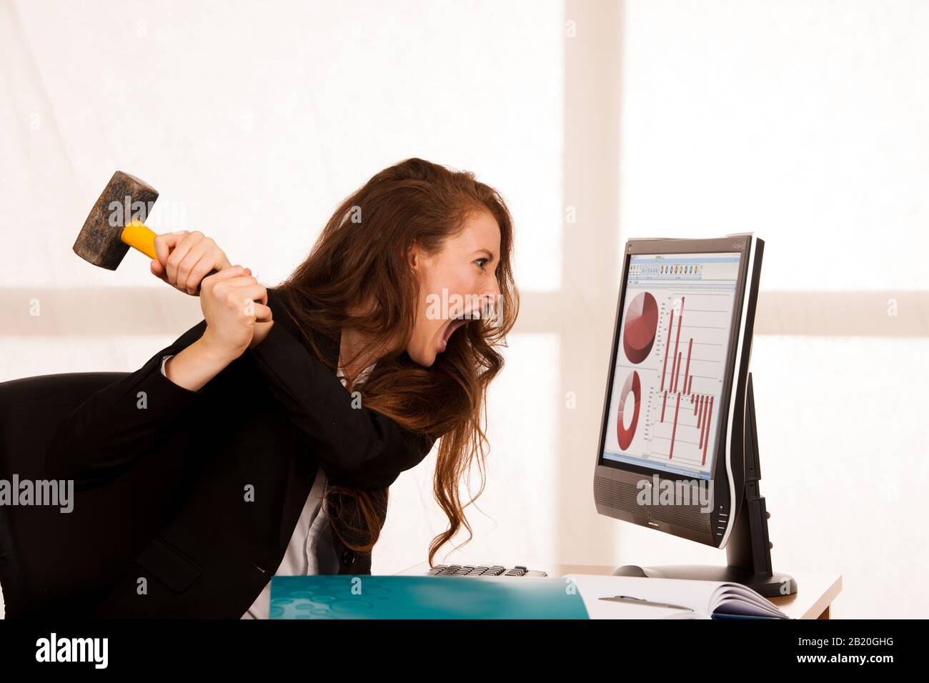 Angry business woman expressing rage at her desk in the office Stock ...