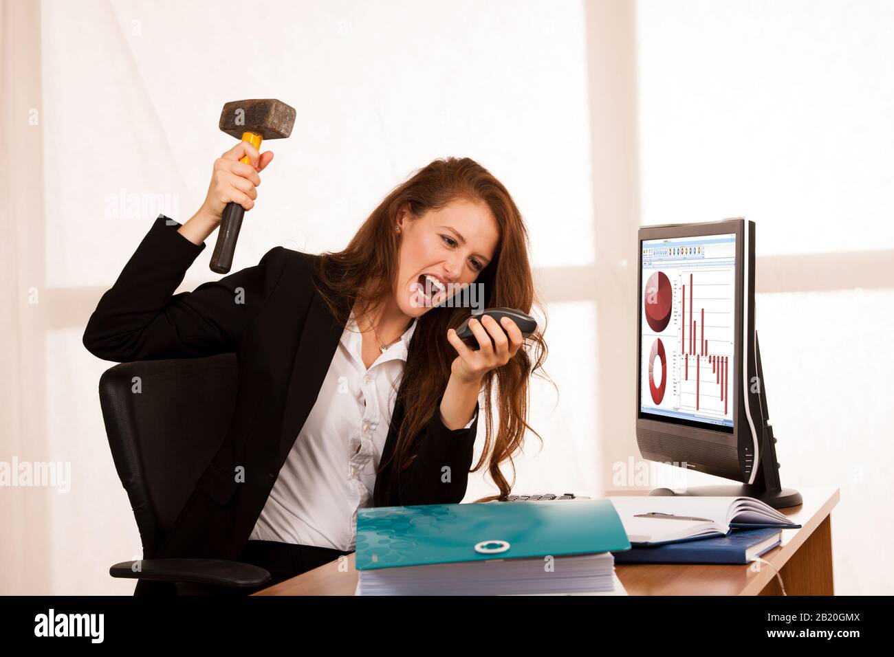 Angry business woman expressing rage at her desk in the office Stock ...