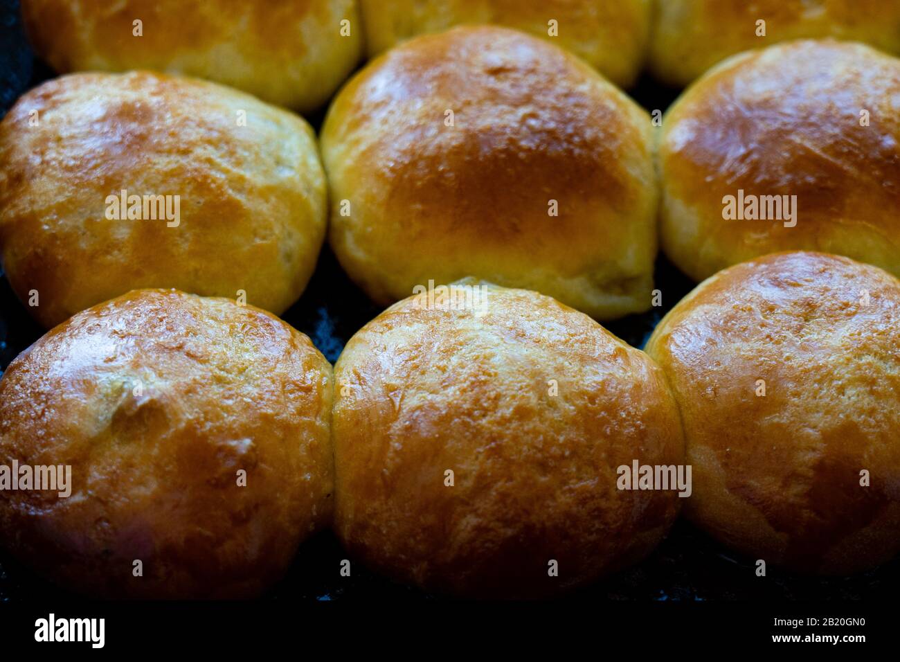 Baked hot buns. Sweet buns on a baking sheet Stock Photo - Alamy