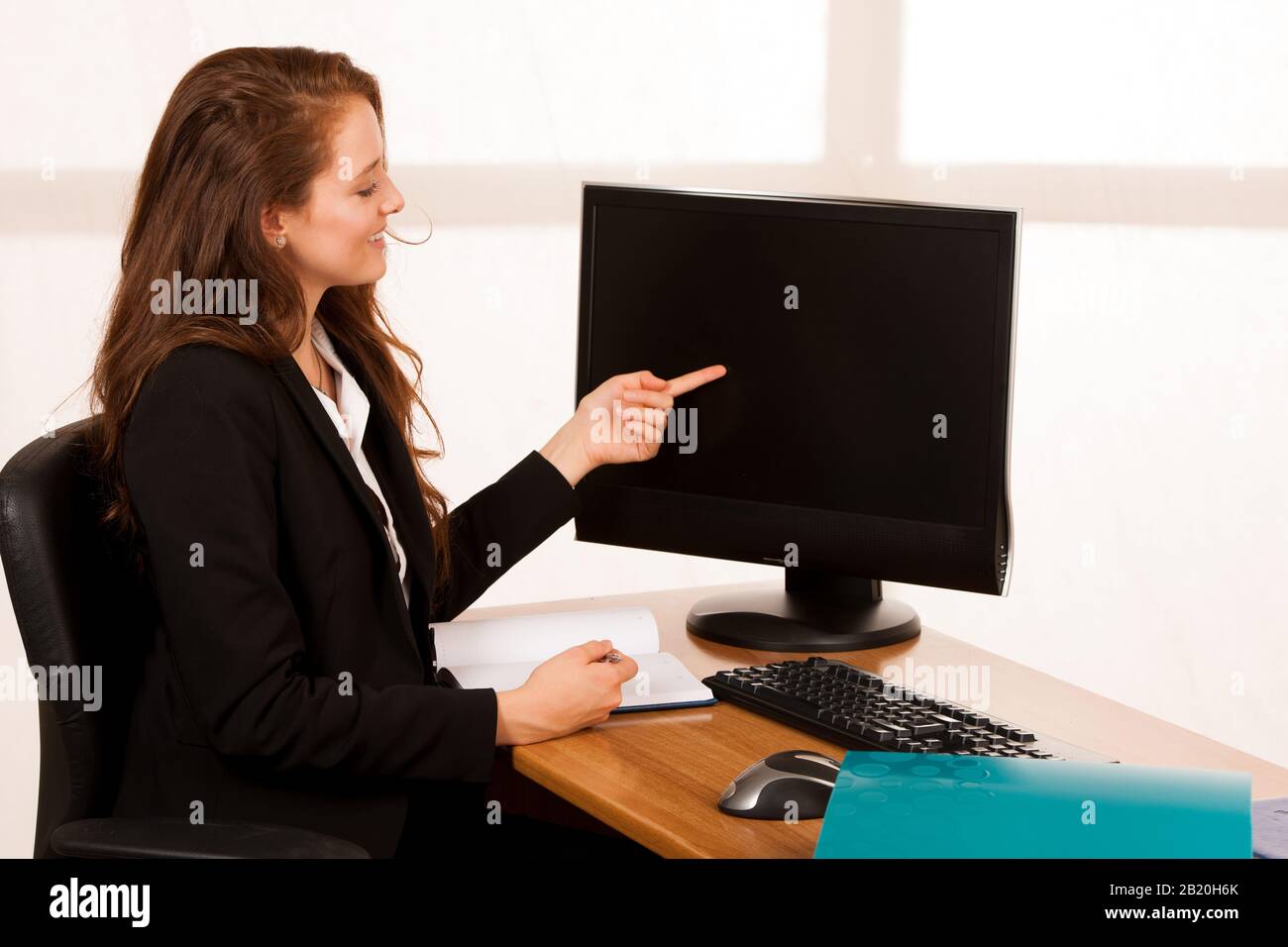 Baeutiful young business woman working at her desk in the office ...
