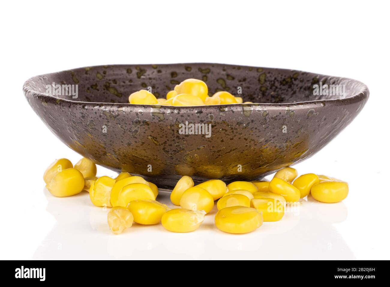 Lot of pieces of canned yellow corn in glazed bowl isolated on white ...