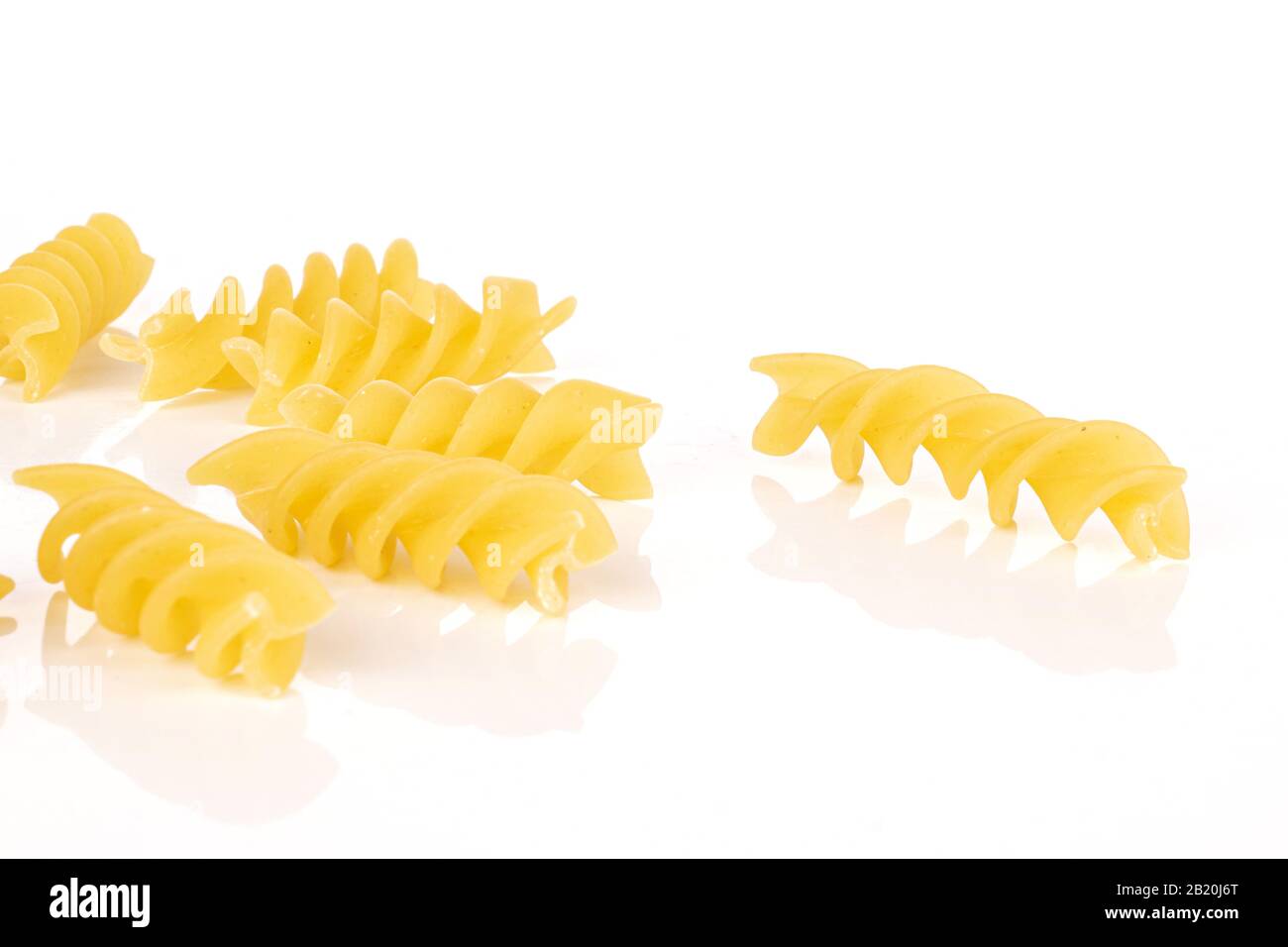 Group of seven whole light yellow pasta fusilli isolated on white ...