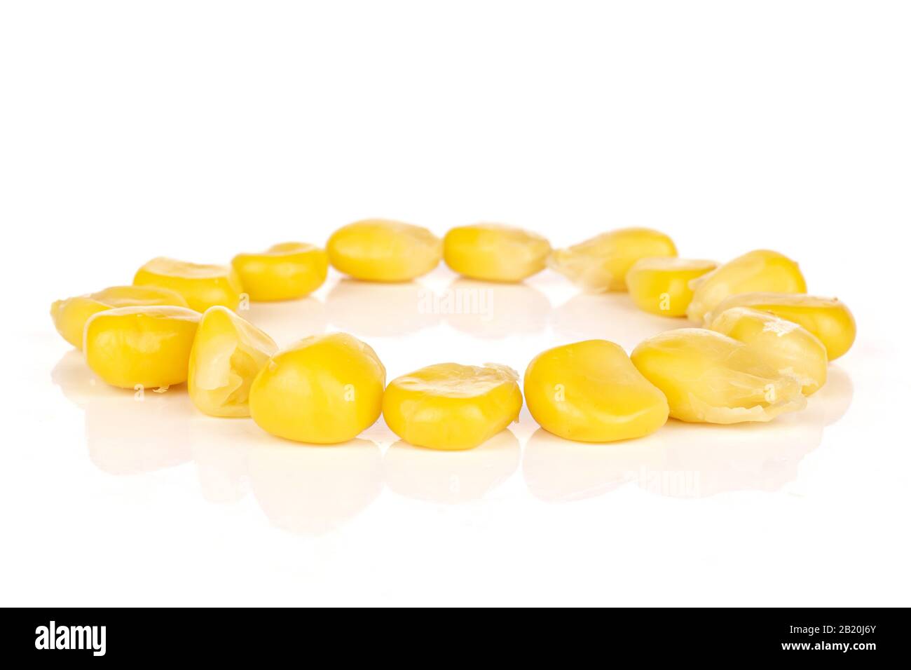 Lot of pieces of canned yellow corn ring isolated on white background ...