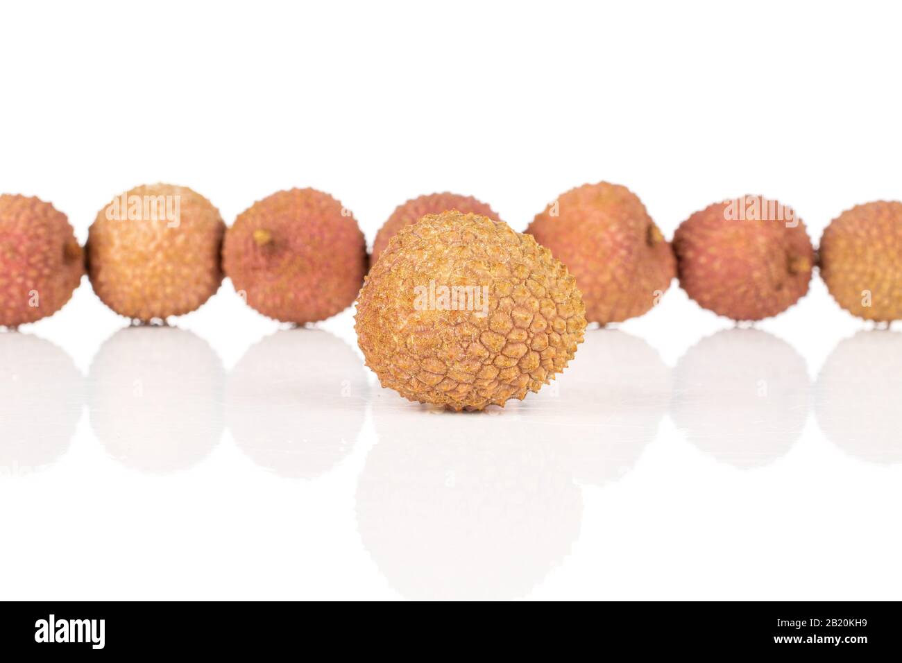 Group of eight whole fresh lychee one in focus isolated on white ...