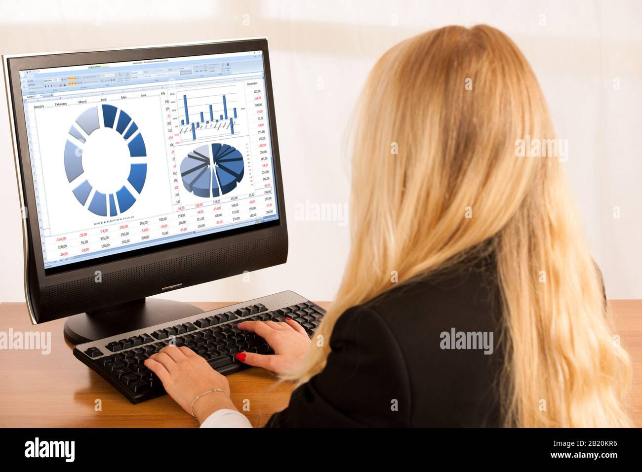 Beautiful young blonde woman working on computer in her office Stock ...