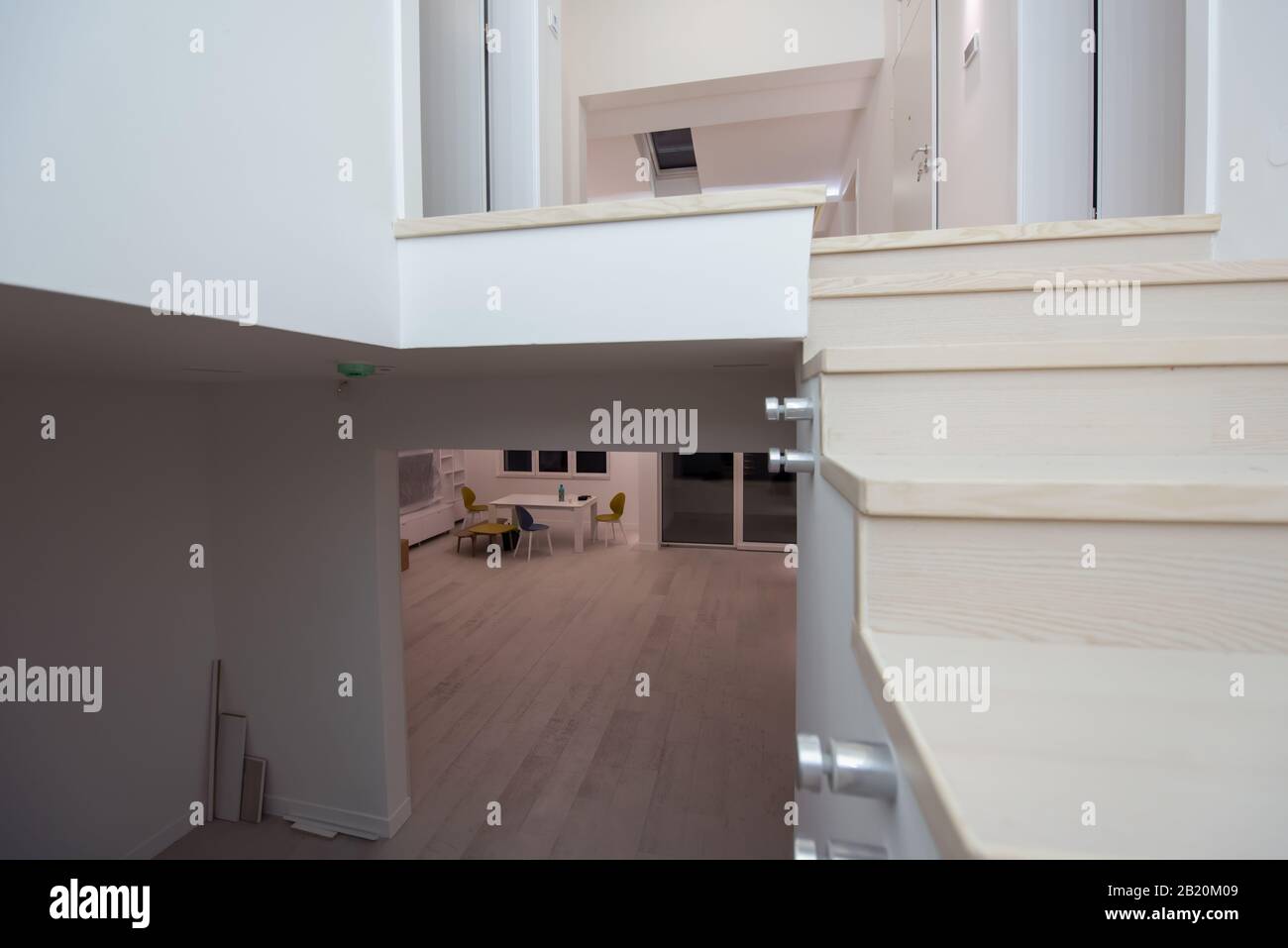 stylish interior with wooden stairs in big modern two level luxury ...