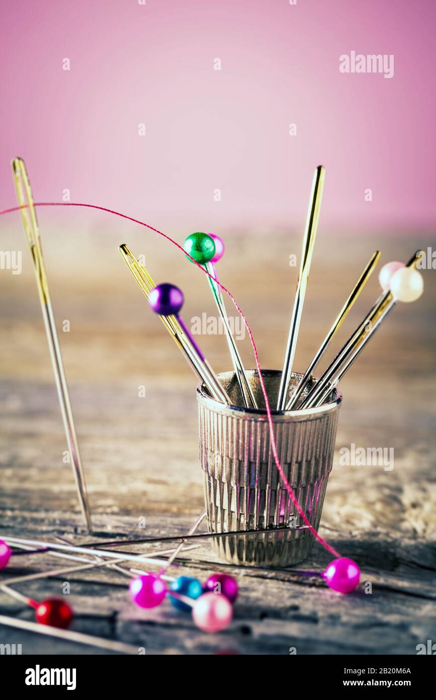 spool of thread with needles and thimble Stock Photo - Alamy