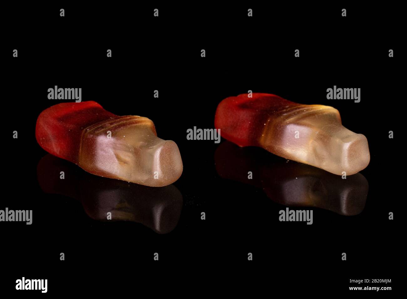Group of two whole sweet jelly cola isolated on black glass Stock Photo ...