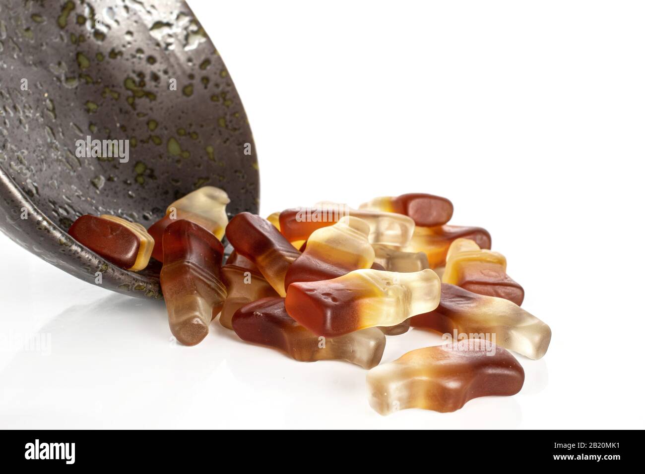 Lot of whole sweet sweet jelly cola in glazed bowl isolated on white ...