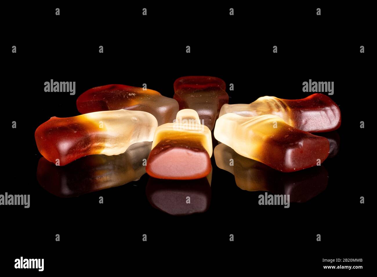 Group of six whole sweet sweet jelly cola isolated on black glass Stock ...