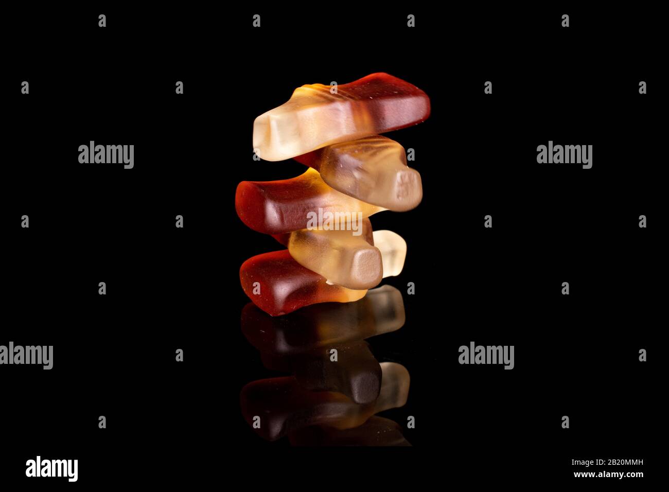 Group of five whole sweet jelly cola isolated on black glass Stock ...
