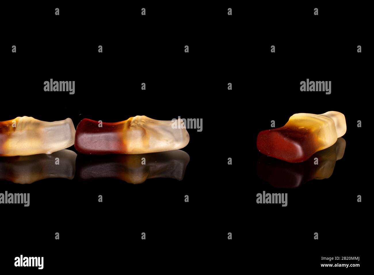Group of three whole sweet jelly cola isolated on black glass Stock ...