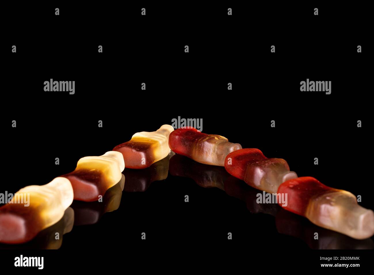 Group of six whole sweet jelly cola isolated on black glass Stock Photo ...