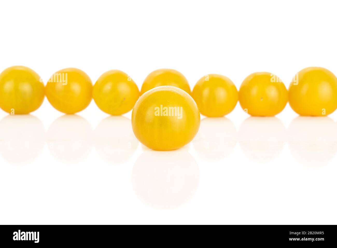 Group of eight whole fresh yellow tomato isolated on white background ...