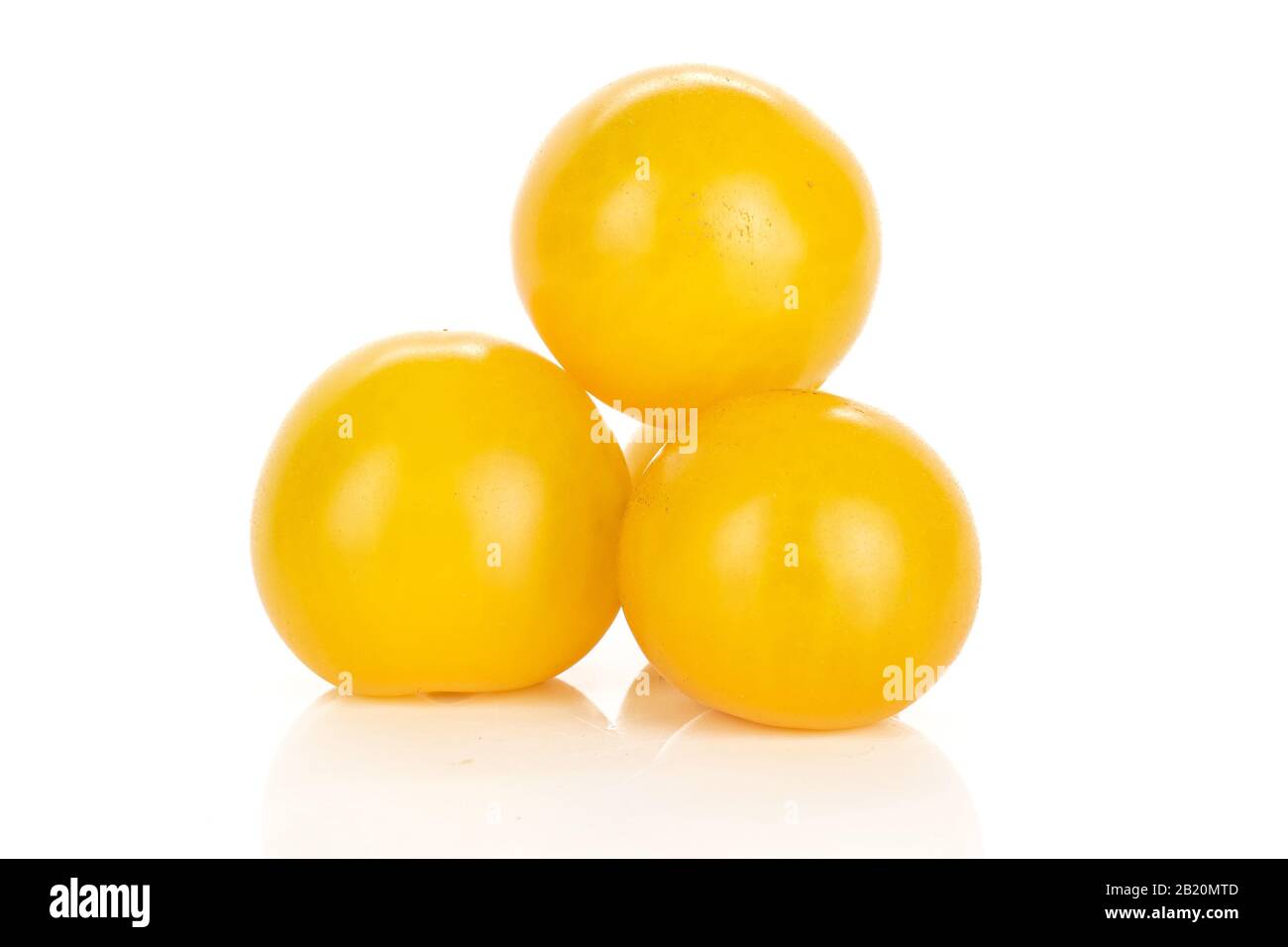 Group of three whole fresh yellow tomato isolated on white background ...