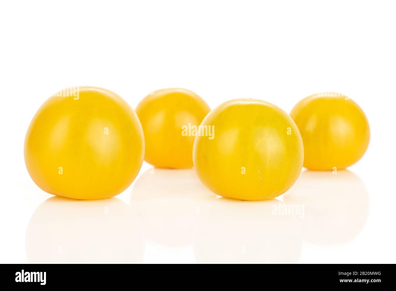 Group of four whole fresh yellow tomato isolated on white background ...