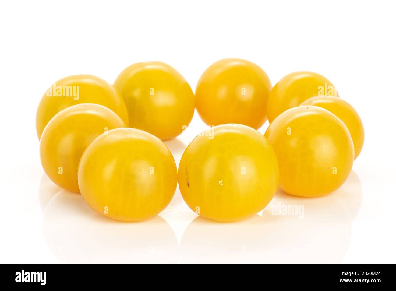 Group of nine whole fresh yellow tomato isolated on white background ...