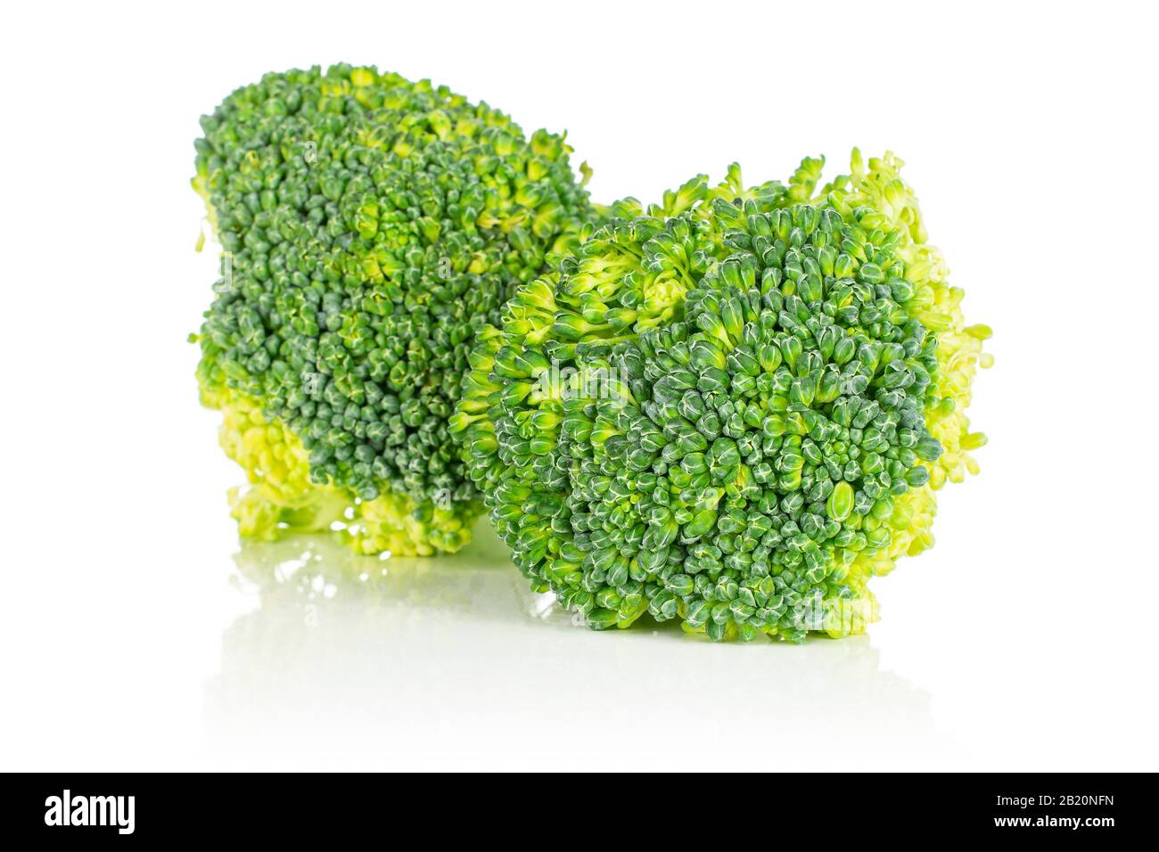 Group of two whole fresh green broccoli head isolated on white ...