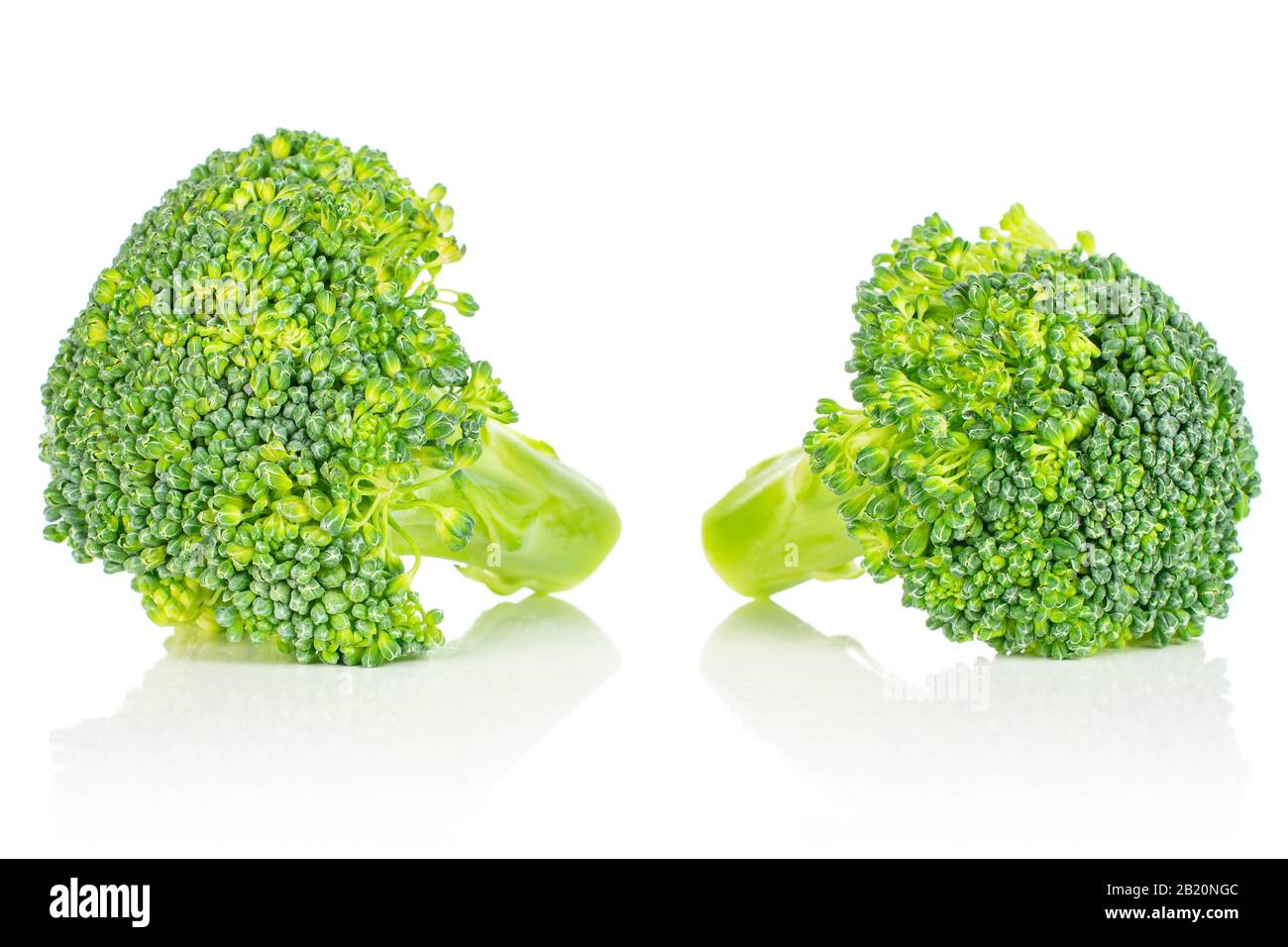 Group of two whole fresh green broccoli head isolated on white ...