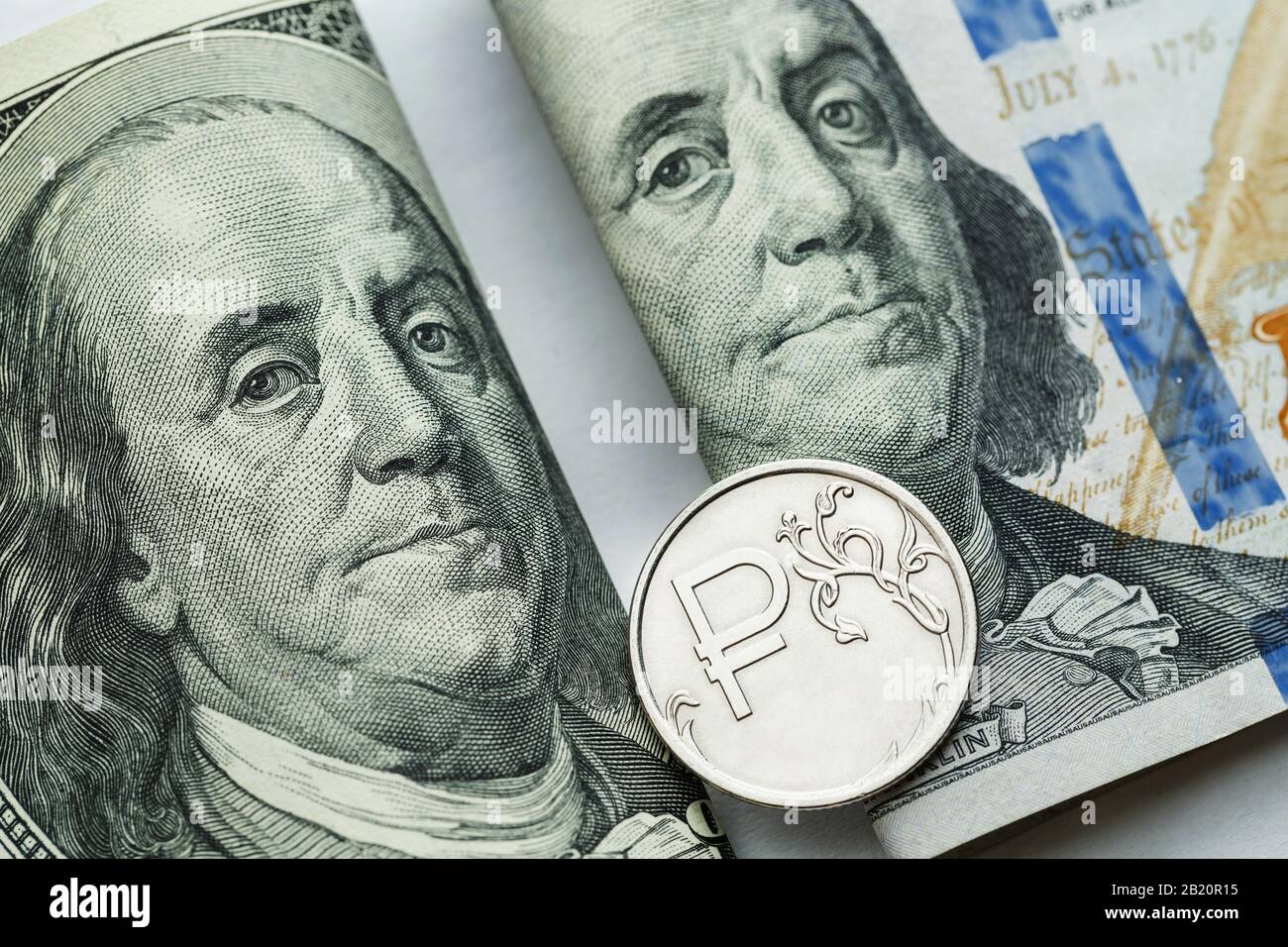Russian one ruble coins and usa one hundred dollar banknotes, face ...