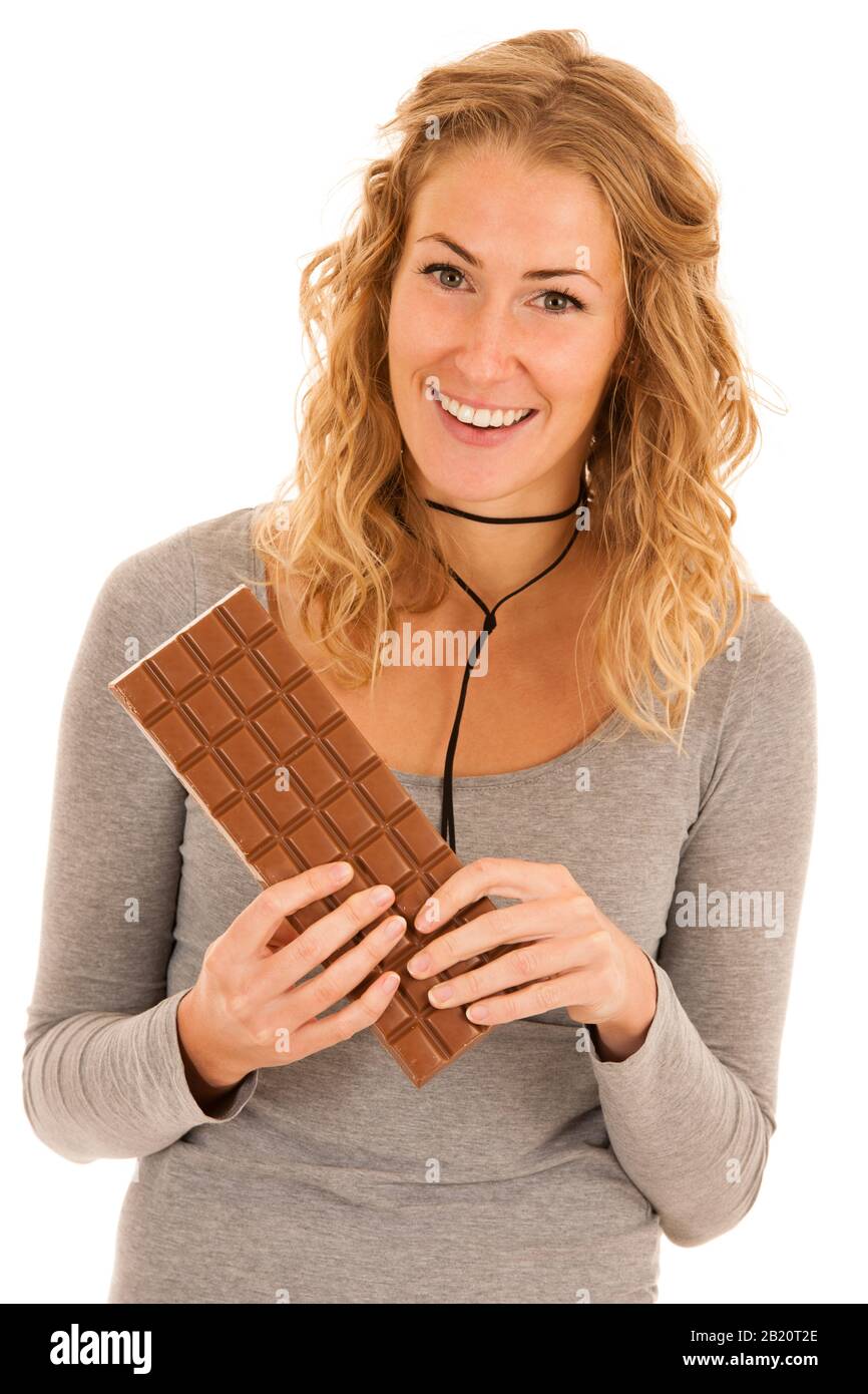 Cute young woman eating chocolate isolated over white background Stock ...