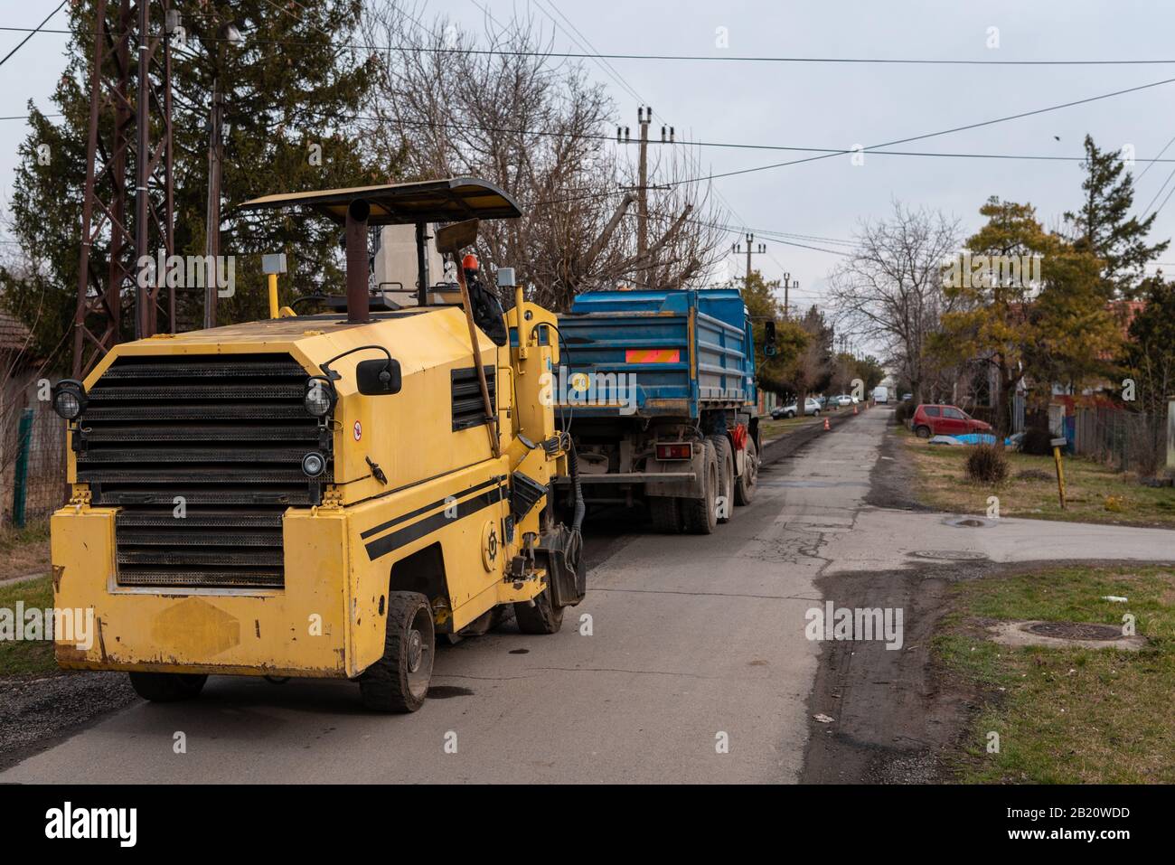Workers with machinery preparing the road for new asphalt Stock Photo ...