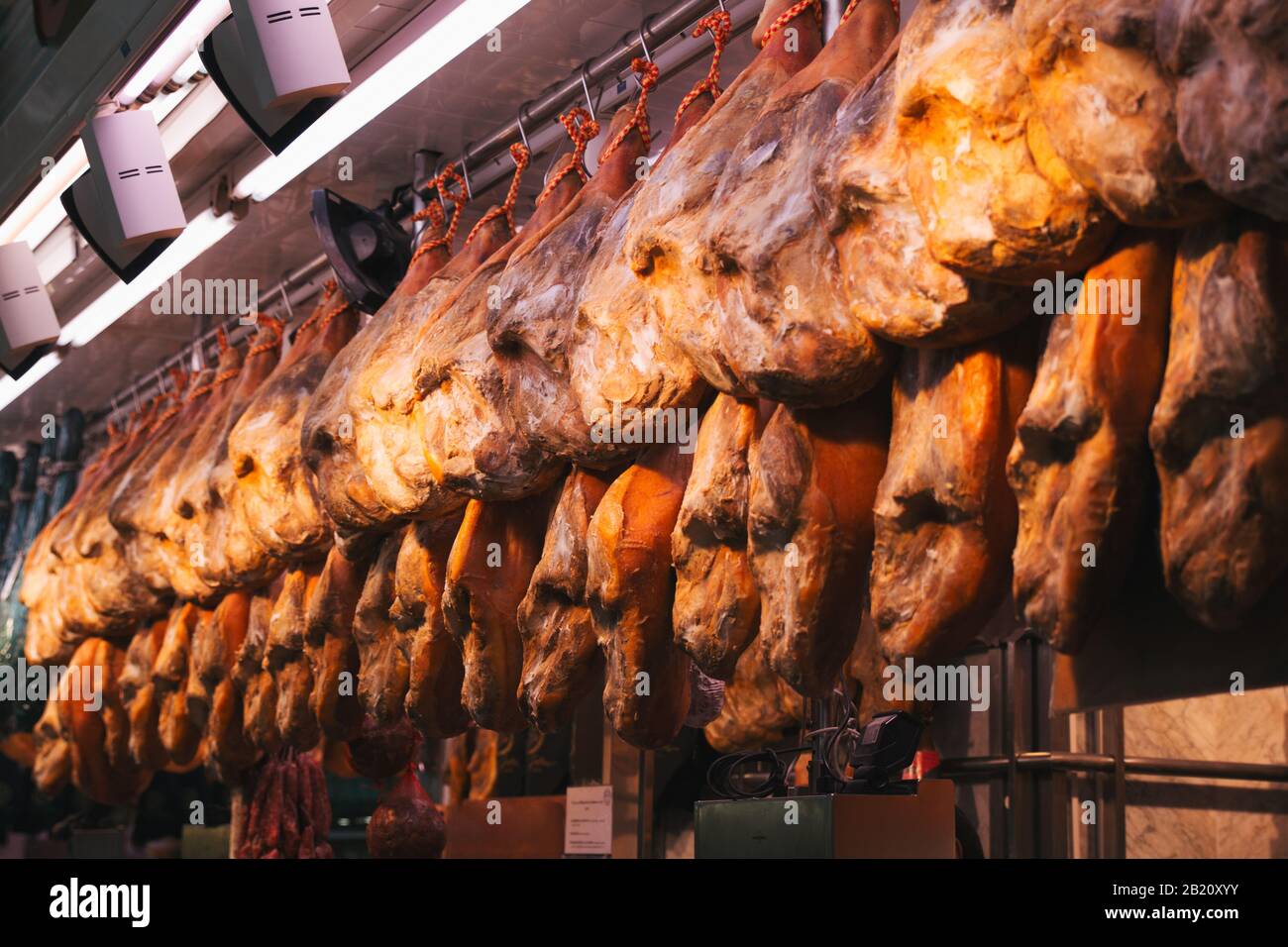 Stock photo of a pile of Iberian ham legs hanging at a market stall ...