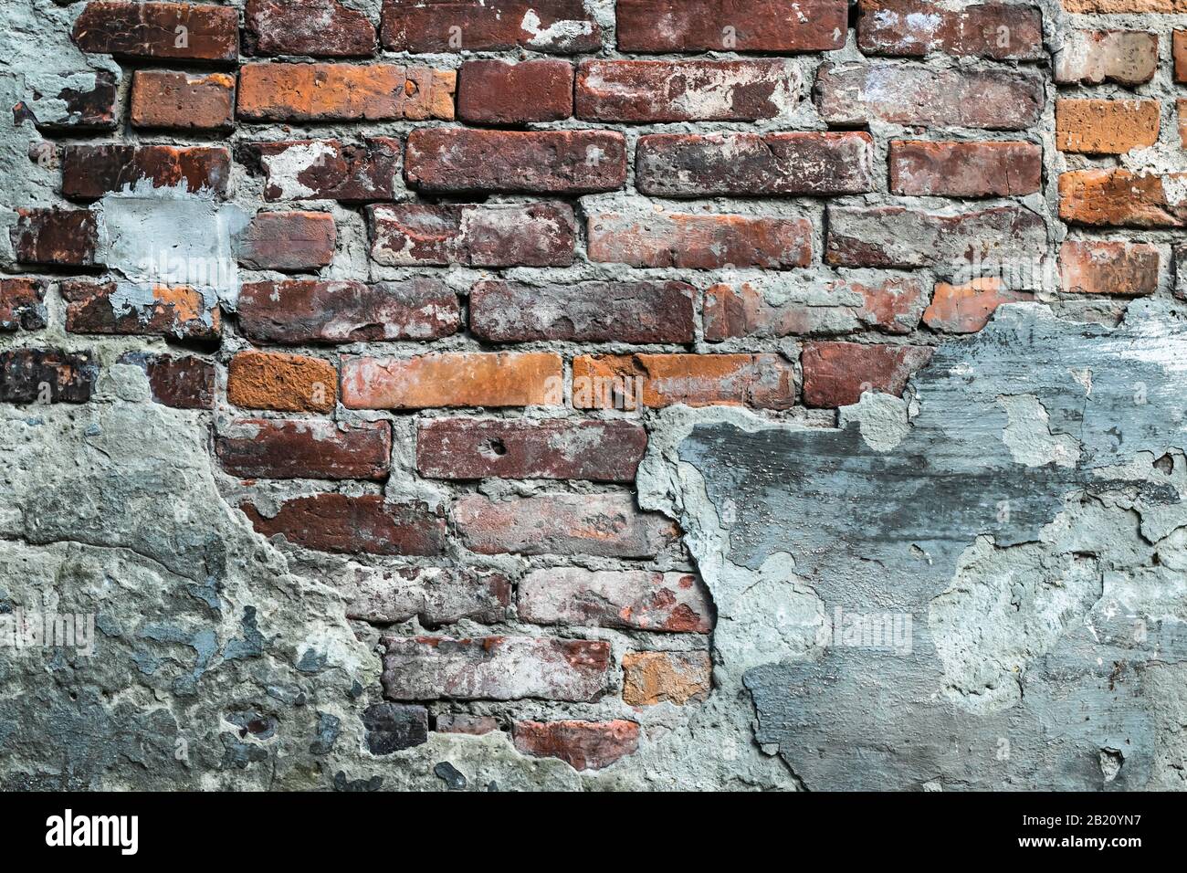 Dilapidated red brick wall, old ruined facade. Urban grunge stonewall, destroyed building ...