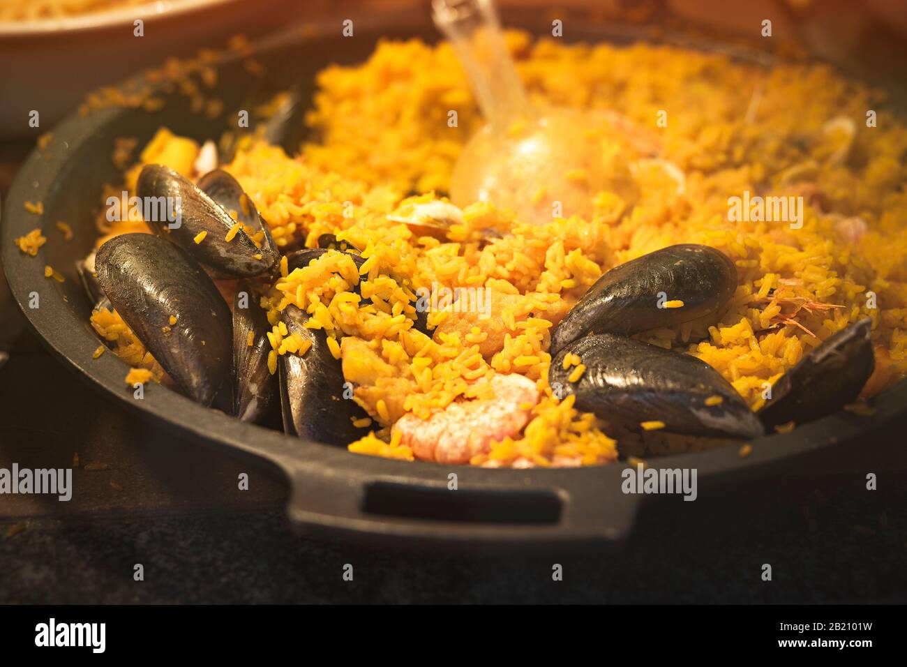 typical spanish paella with yellow rice and seafood Stock Photo - Alamy