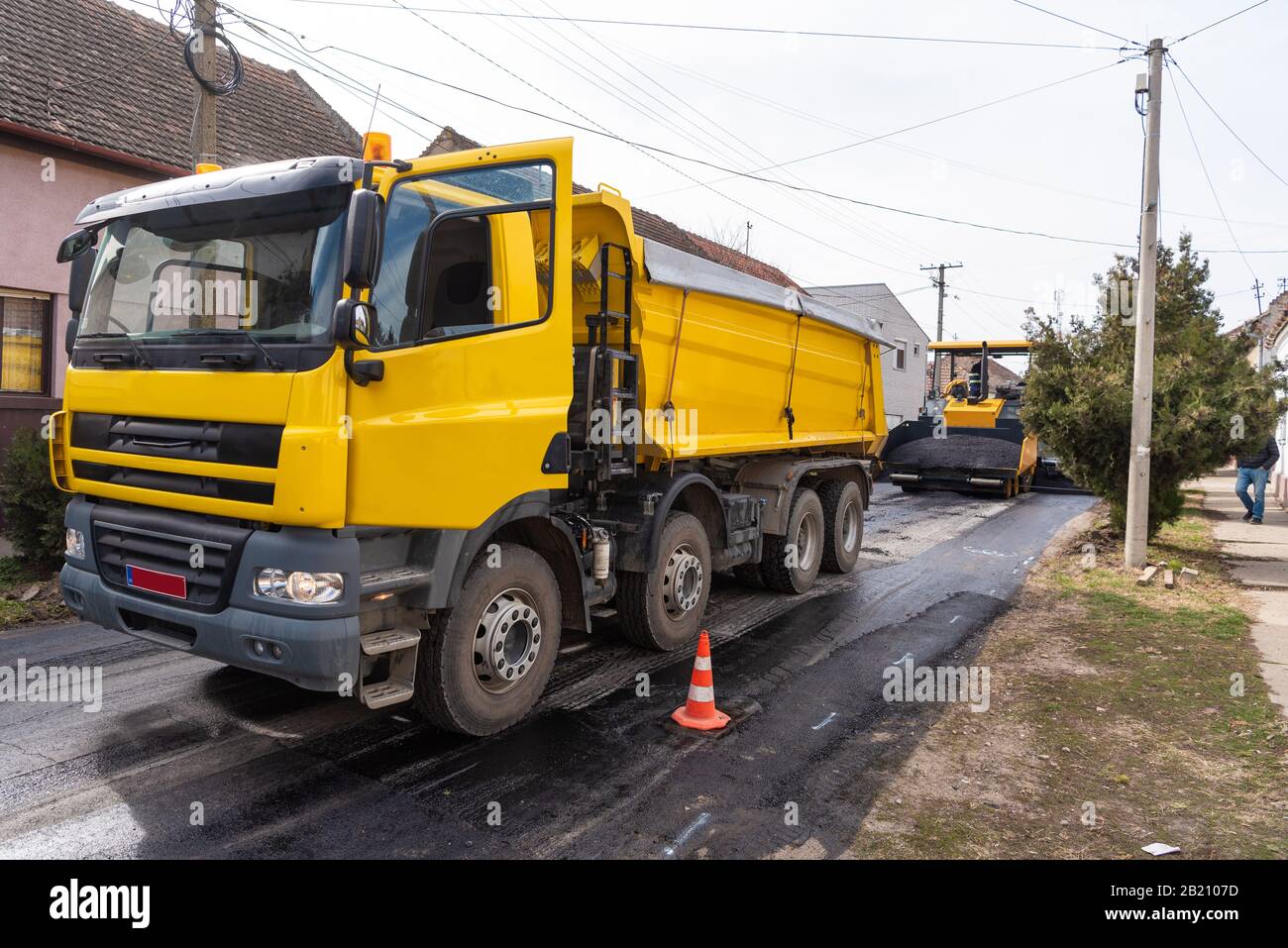 Workers with machinery preparing the road for new asphalt Stock Photo ...