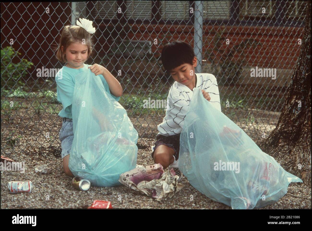 Eight and nine-year-old children pick up litter at school ...