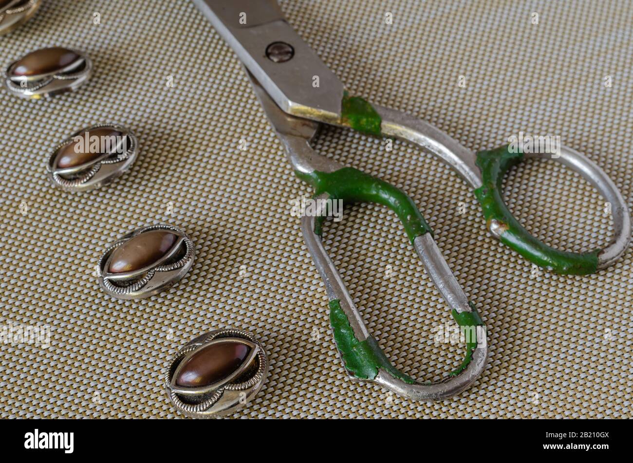 A row of buttons and old scissors on the table. A line of Five Elegant ...