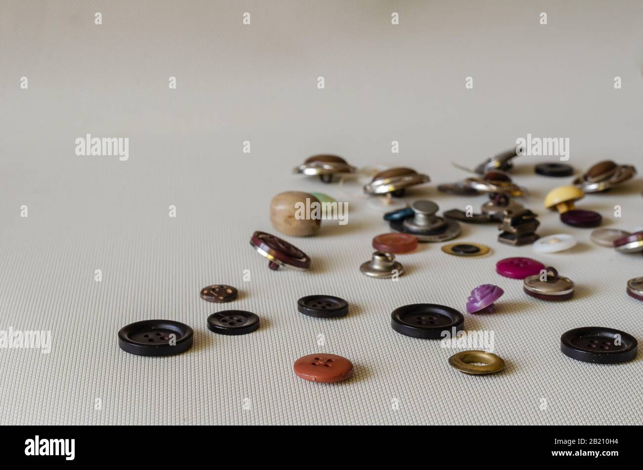 Multi-colored buttons background. Used buttons on a light textured ...