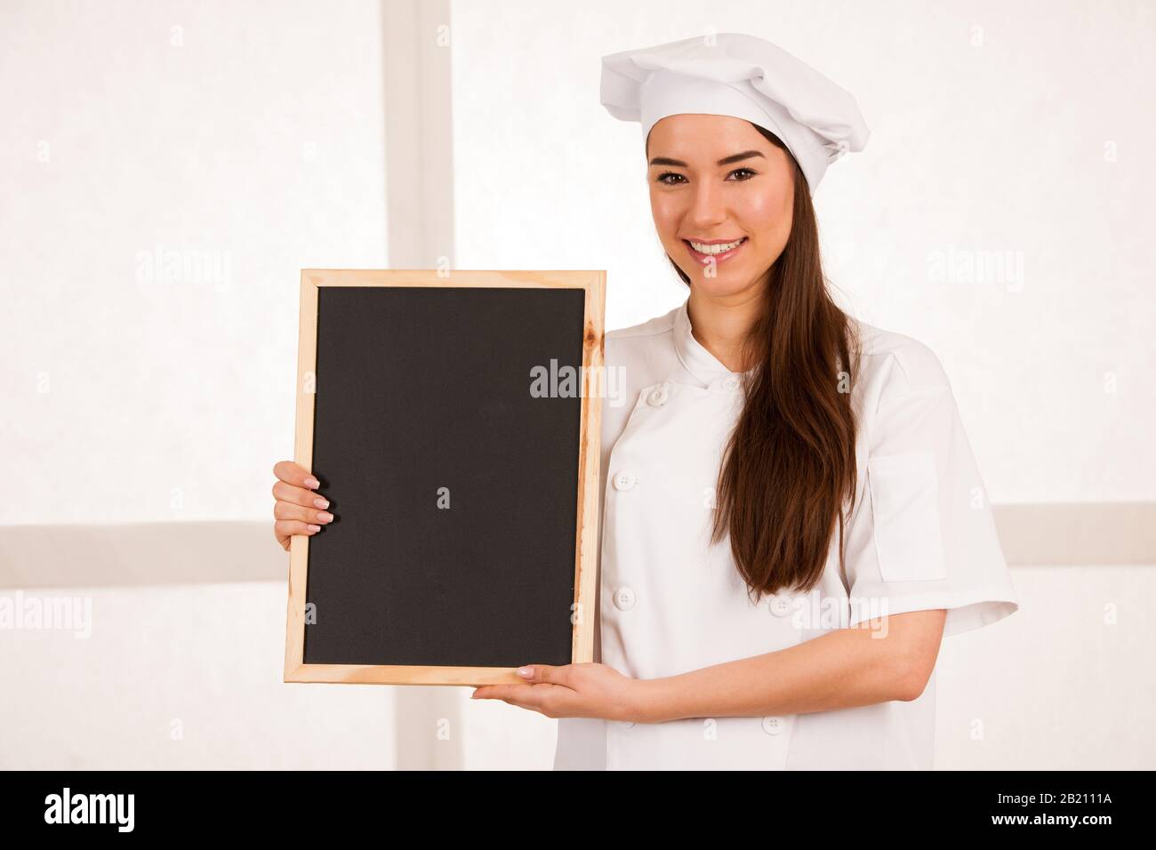 Happy blonde female chef prepares hi-res stock photography and images ...